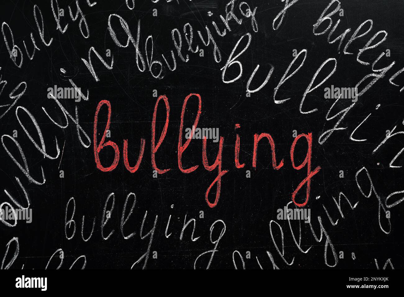 Many words Bullying written on blackboard, closeup view Stock Photo - Alamy