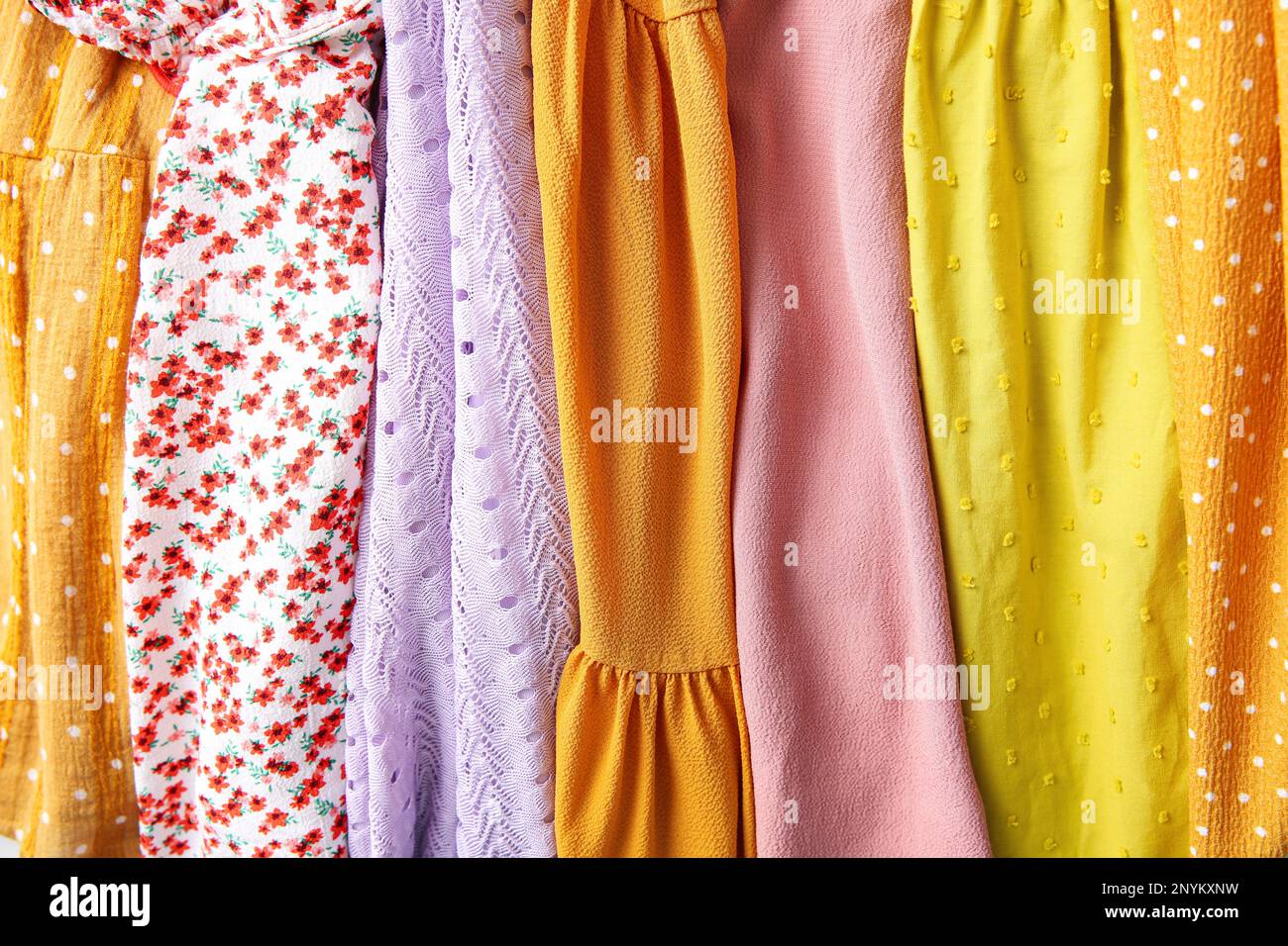 Lots of different clothes as background, top view. Diversity concept ...