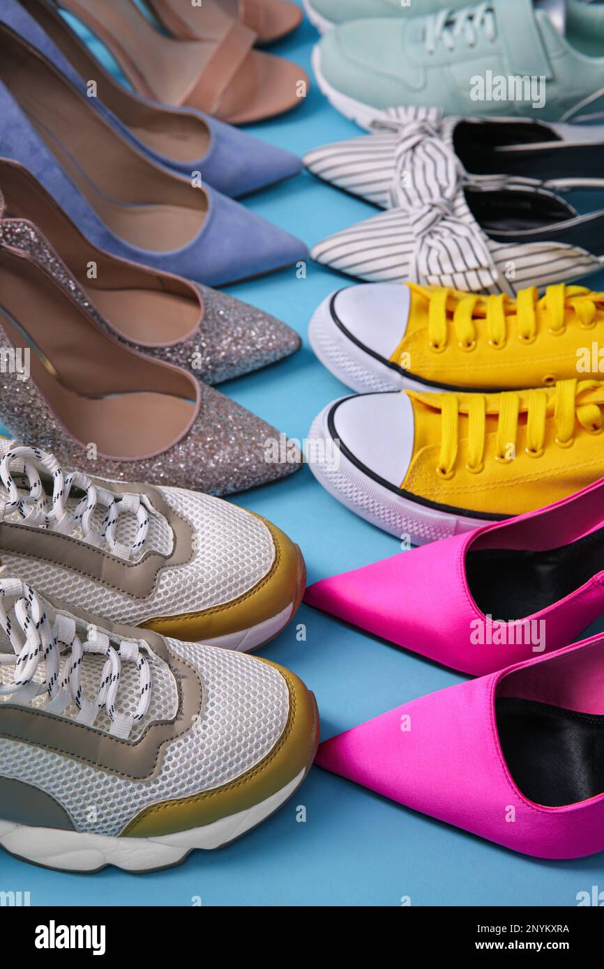 Many different shoes on turquoise background, closeup. Diversity ...