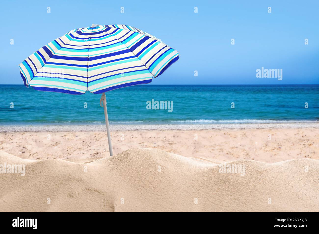 Open big beach umbrella on sandy coast Stock Photo - Alamy