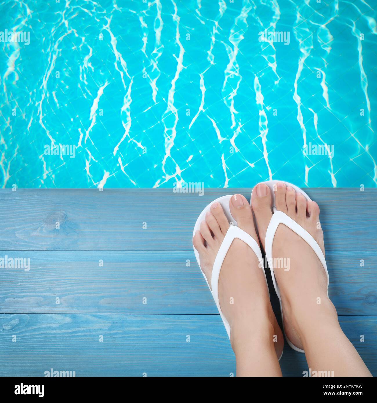 Woman wearing stylish flip flops near swimming pool, top view Stock ...