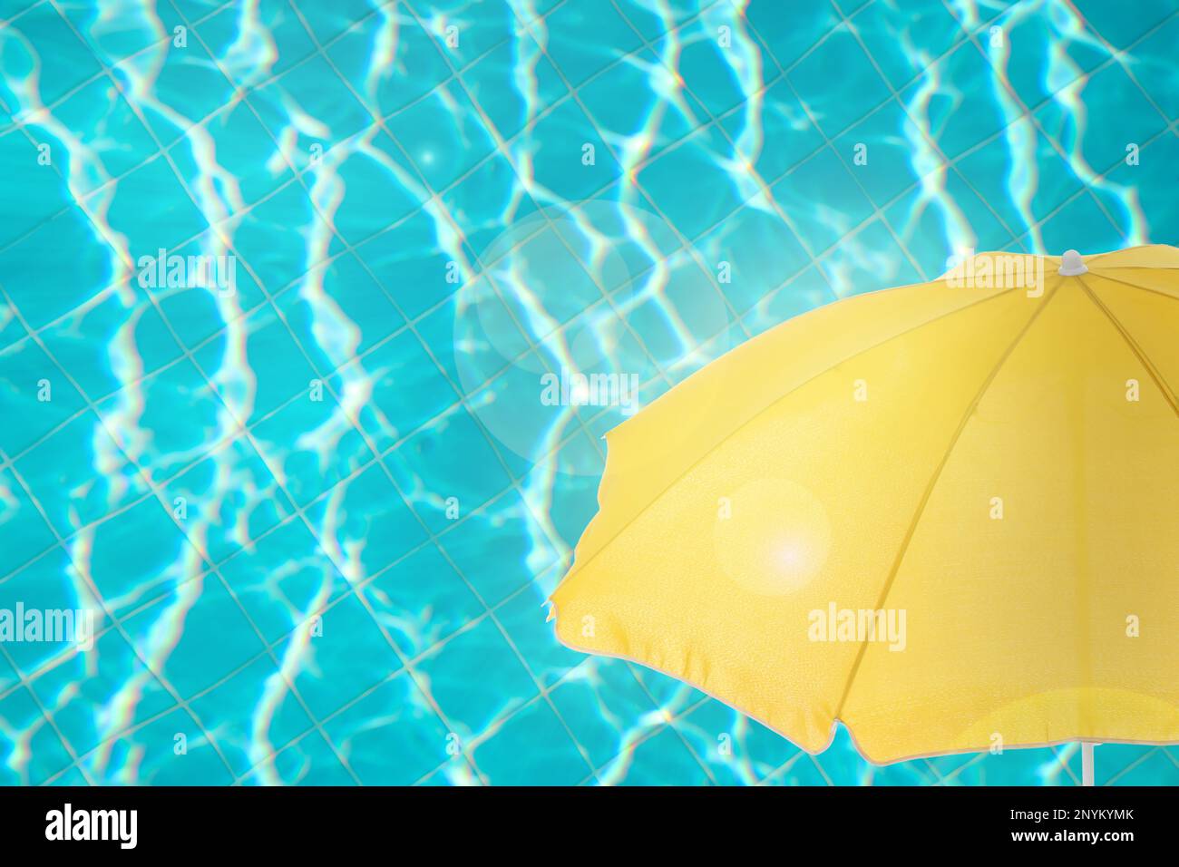 Open beach umbrella and swimming pool. Summer vacation Stock Photo - Alamy