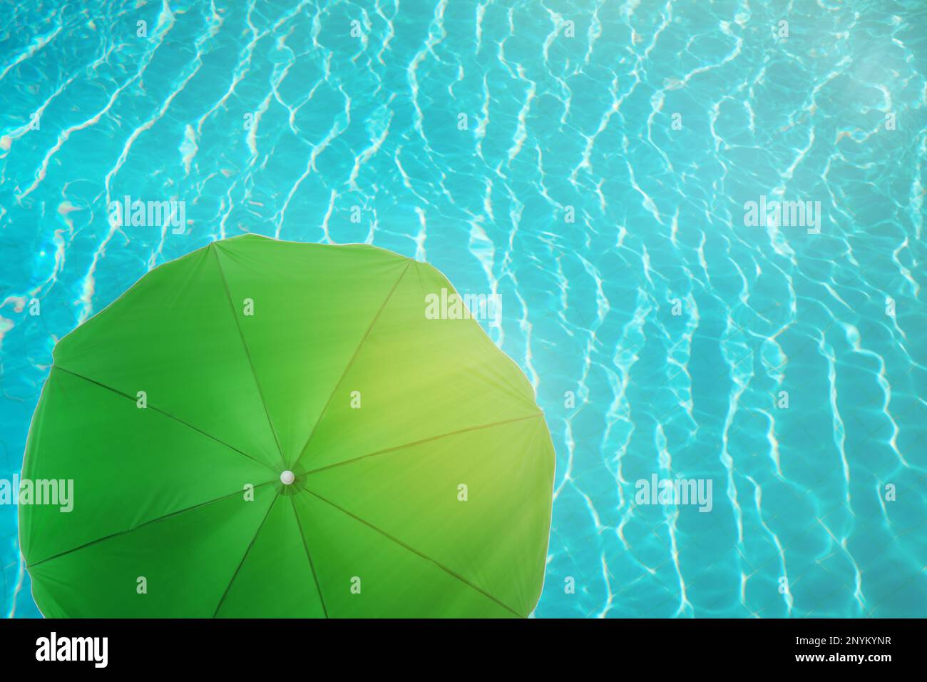 Open beach umbrella and swimming pool. Summer vacation Stock Photo - Alamy