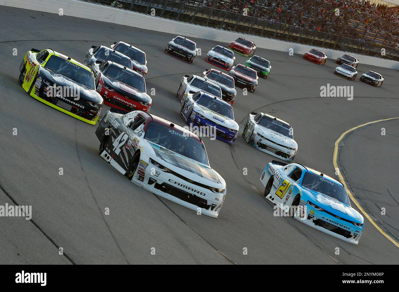 Tyler Reddick (42), Daniel Hemric (21), and Brandon Jones (33) lead a ...
