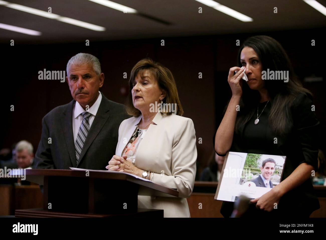 Wayne Friedland stands next to his wife Rose Friedland as she speaks in ...