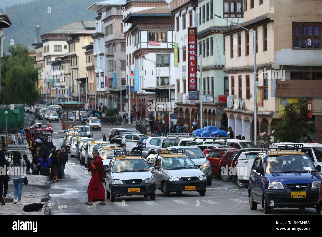 Crowded street without signs in Thimphu, Bhutan. Police officer uses ...