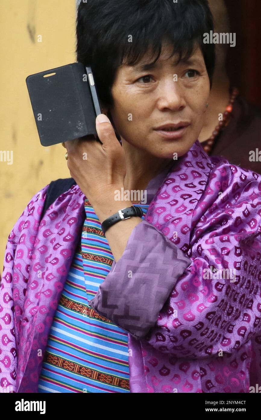 People with smartphones are seen in Thimphu where modernization is ...