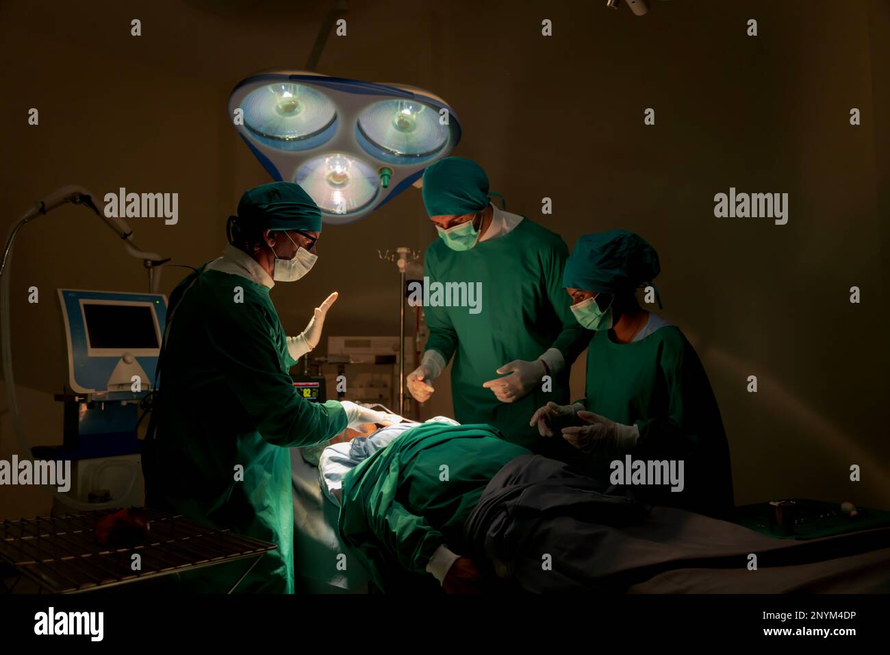 Team doctors operating room dressed green uniforms saving lives ...