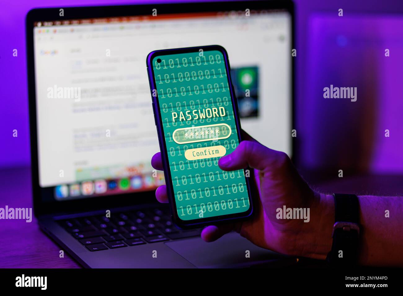 Person typing password on smartphone in laptop background. Digital ...