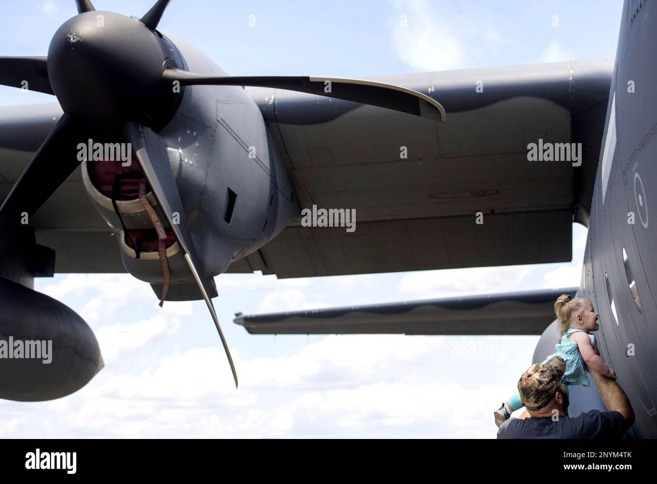 Calvin Myers lifts his daughter Kennedy, 1, to see inside an airplane ...