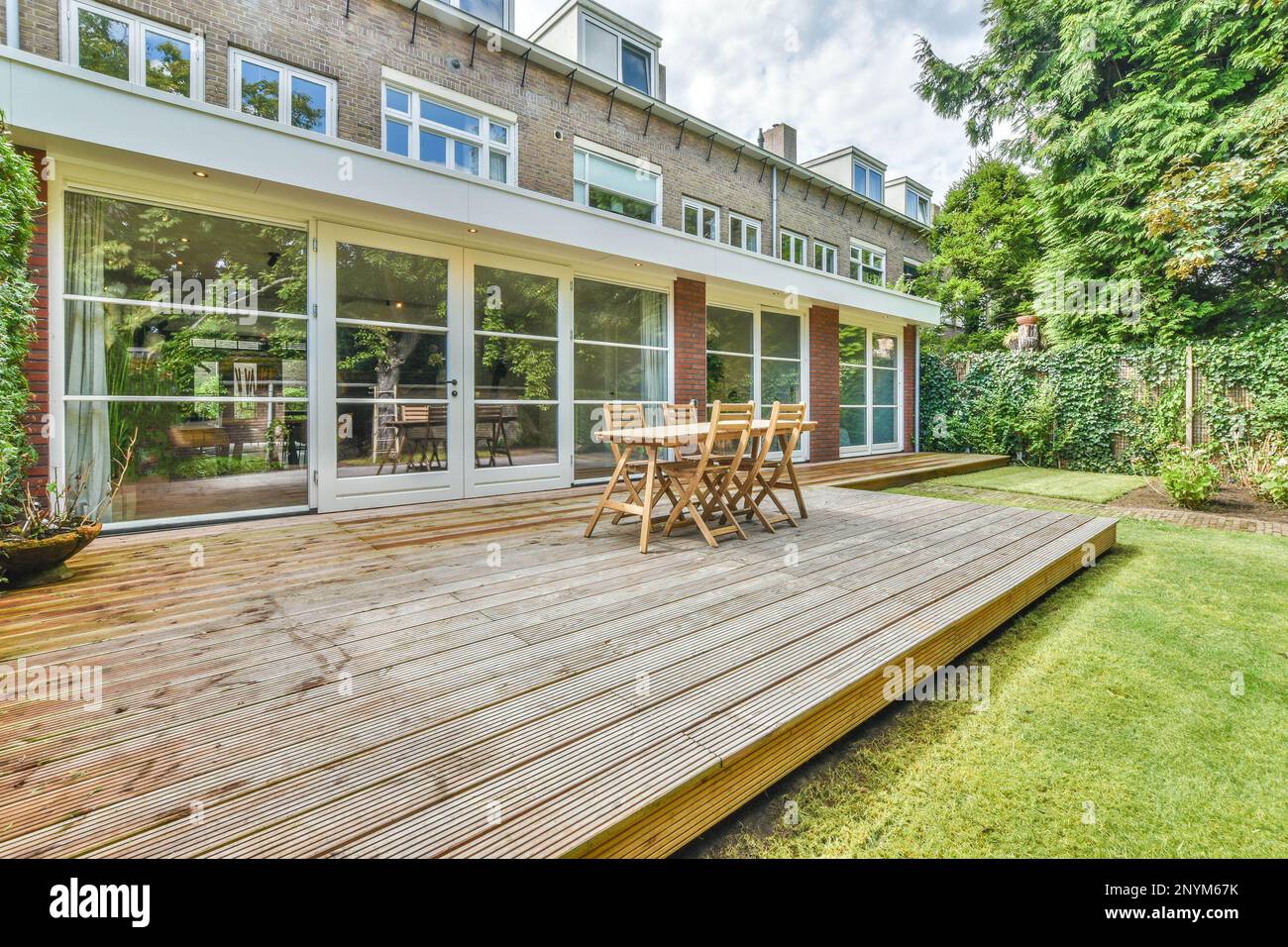 an outdoor patio with wooden decking and sliding glass doors leading ...