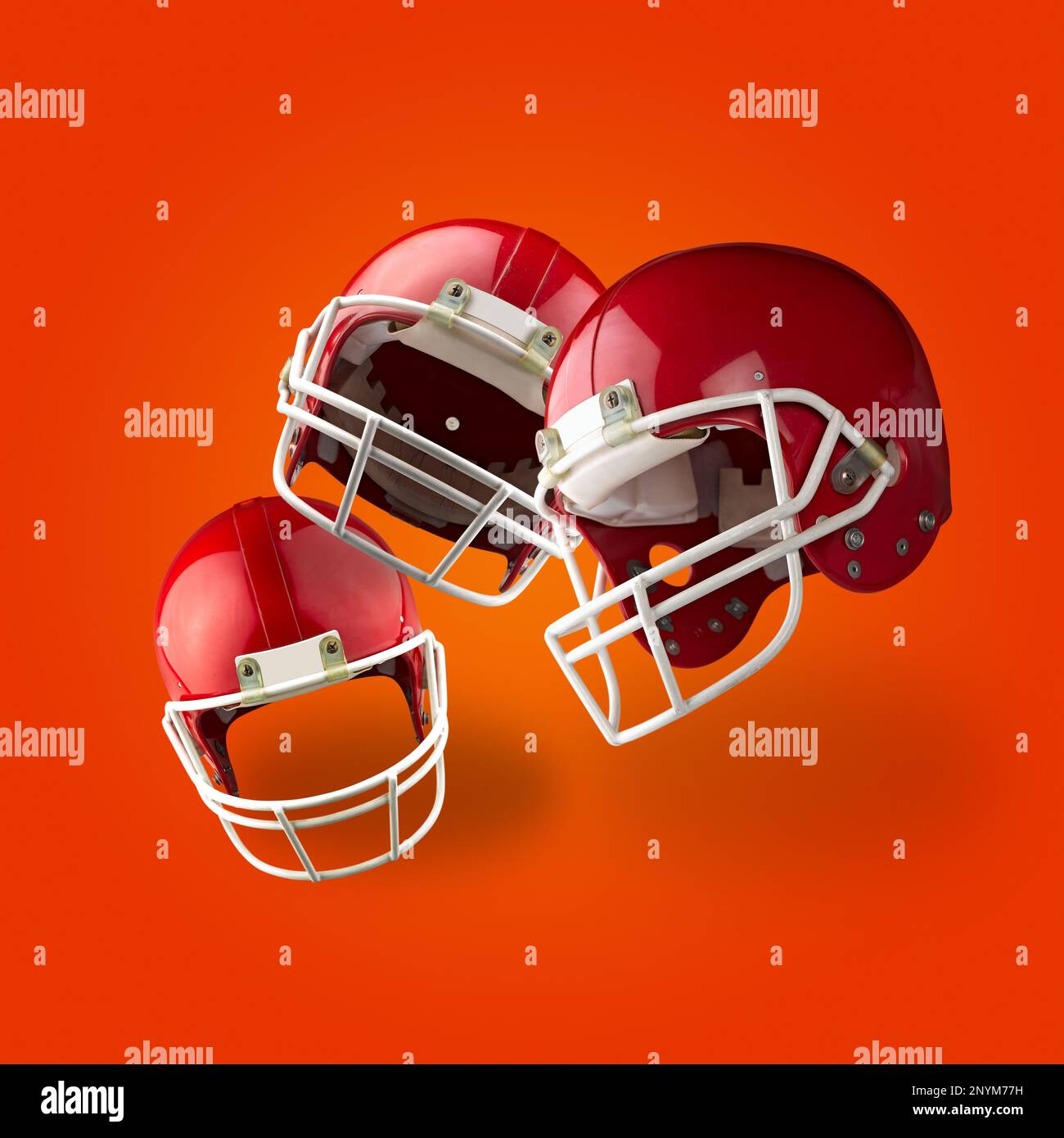 Three Floating Red American football helmets on orange gradient ...
