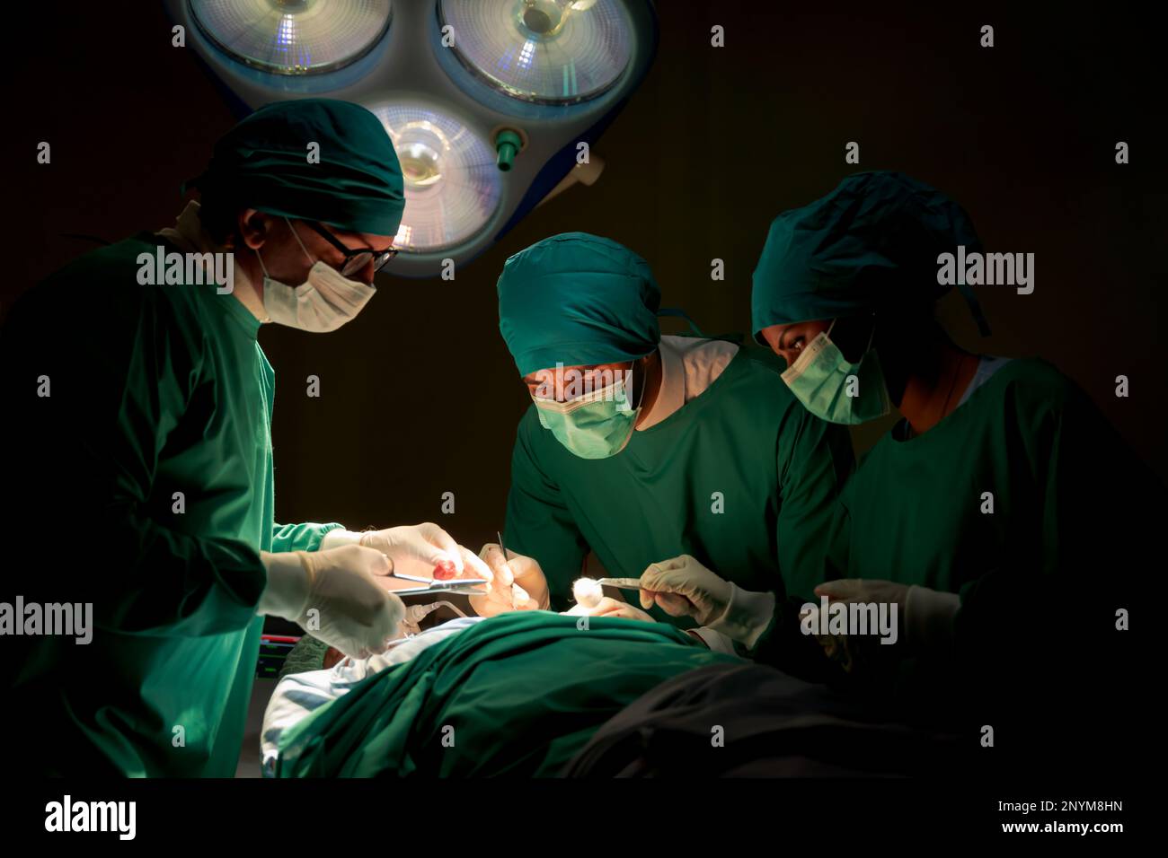 Team doctors operating room dressed green uniforms saving lives ...