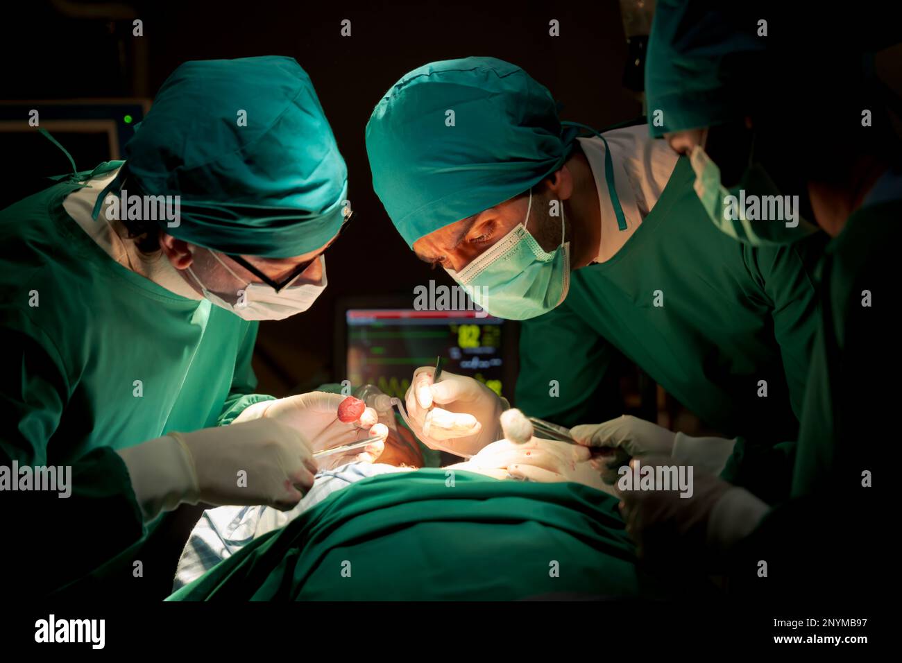 Team doctors operating room dressed green uniforms saving lives ...