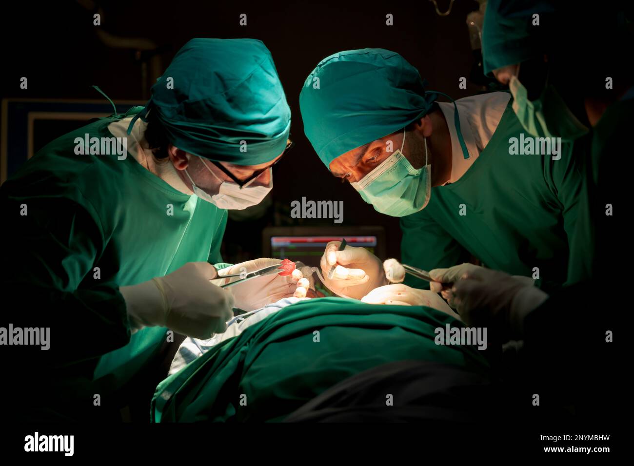 Team doctors operating room dressed green uniforms saving lives ...