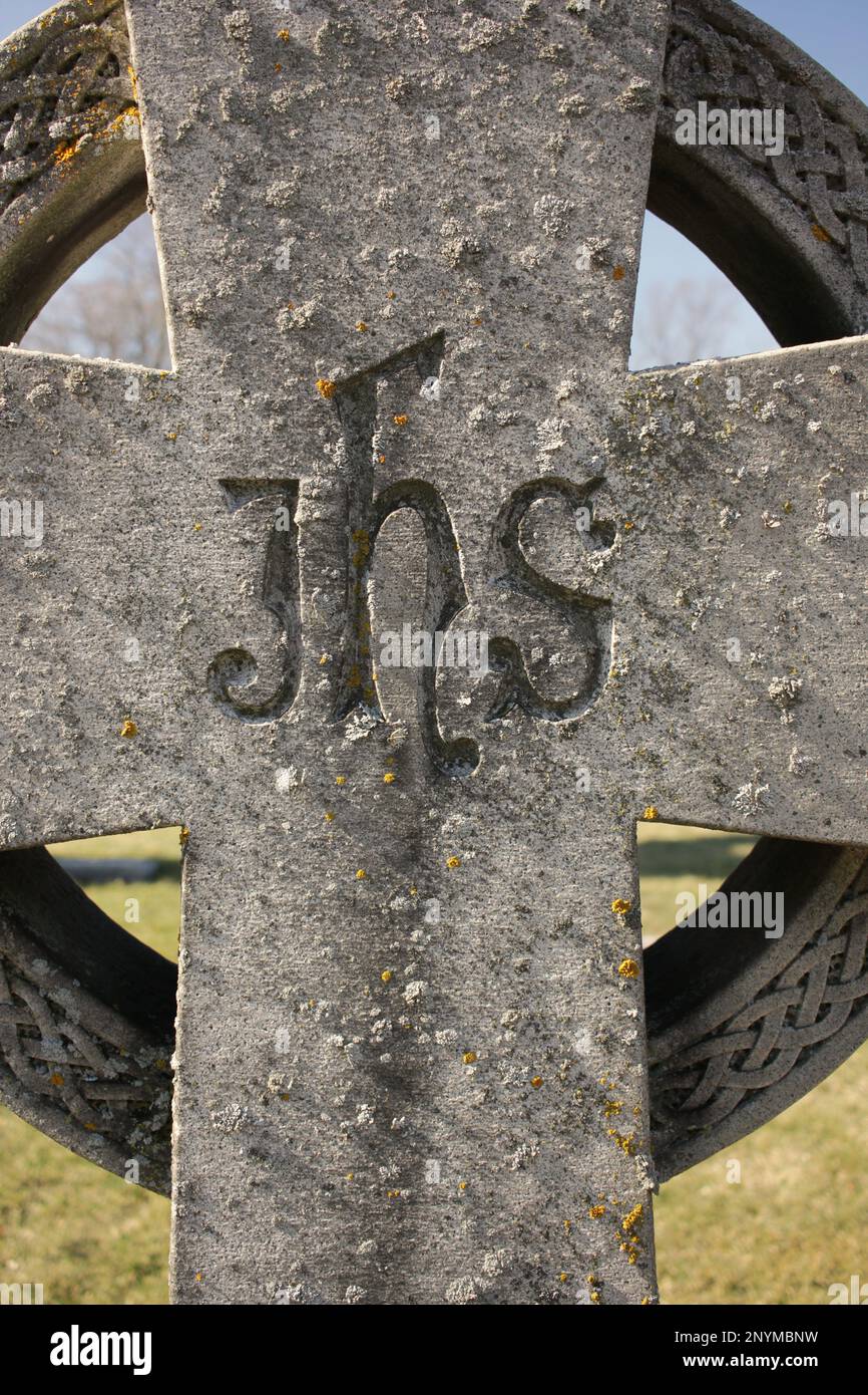 The letters IHS carved into a natural stone cross Stock Photo - Alamy