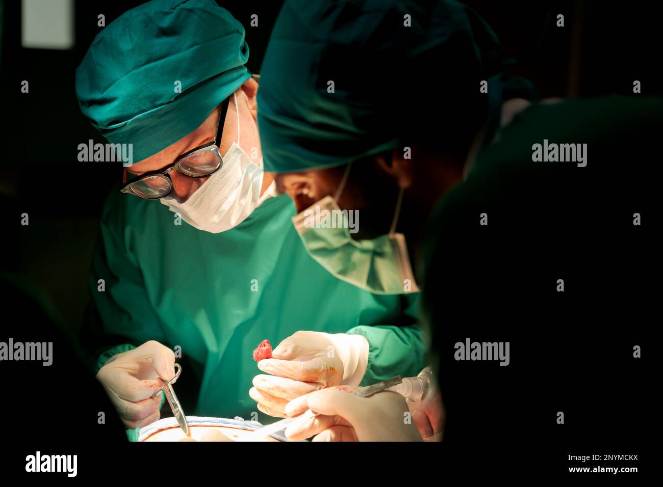 Team doctors operating room dressed green uniforms saving lives ...