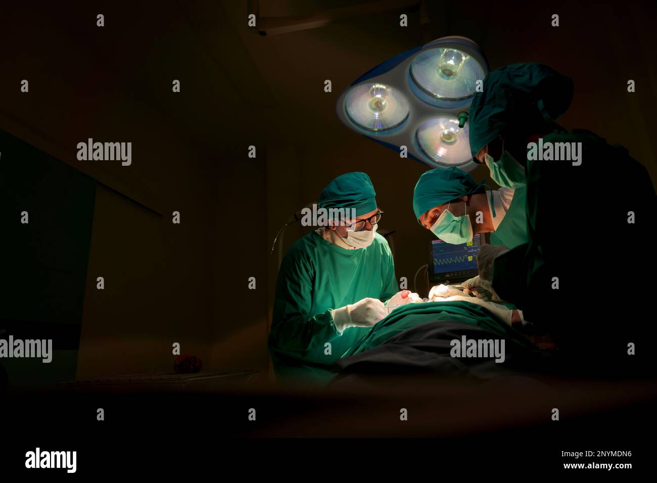 Team doctors operating room dressed green uniforms saving lives ...