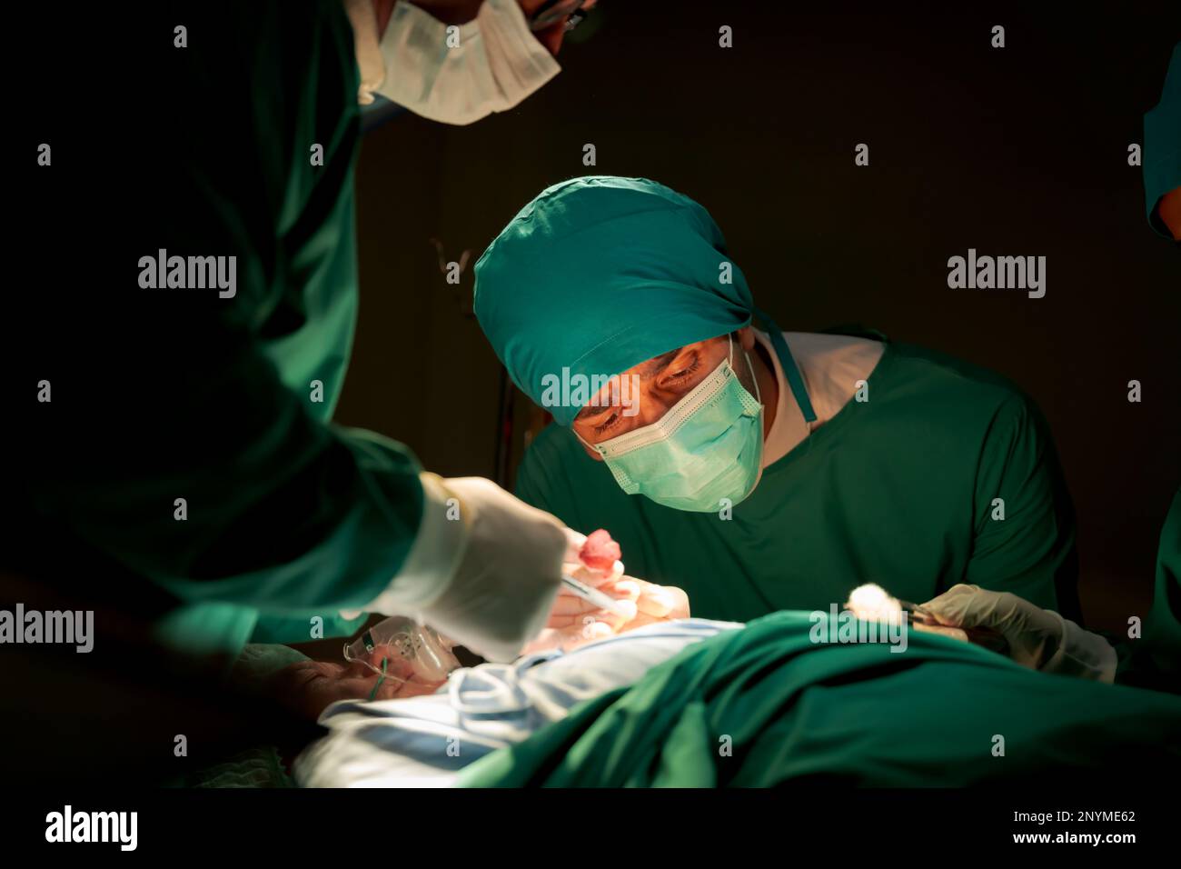 Team doctors operating room dressed green uniforms saving lives ...