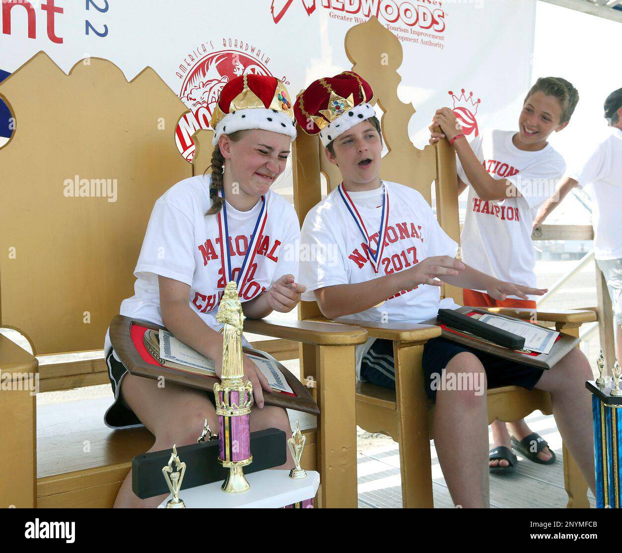 Eli Murphy, right, leans in to give Sierra Ricci the traditional king ...
