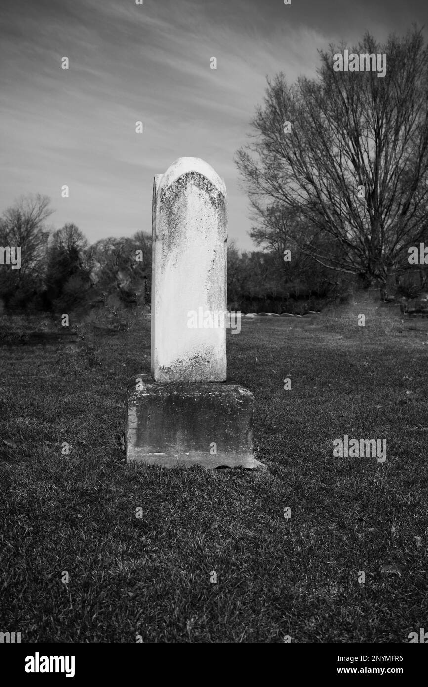 A vintage traditional stone gravestone with a blank epithet and room ...