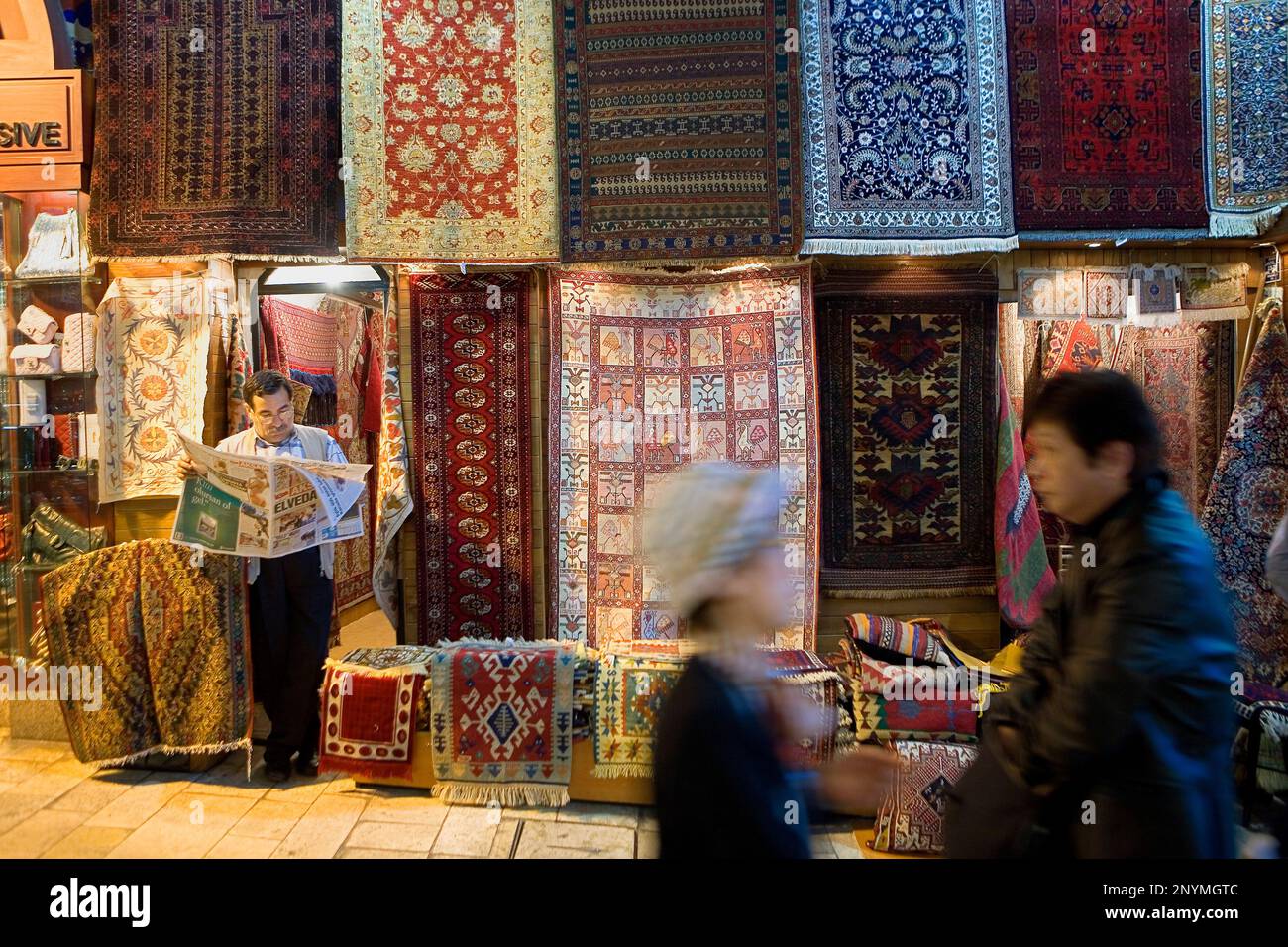 Grand Bazaar,seller reading newspaper,Shop of carpets & kilims ...