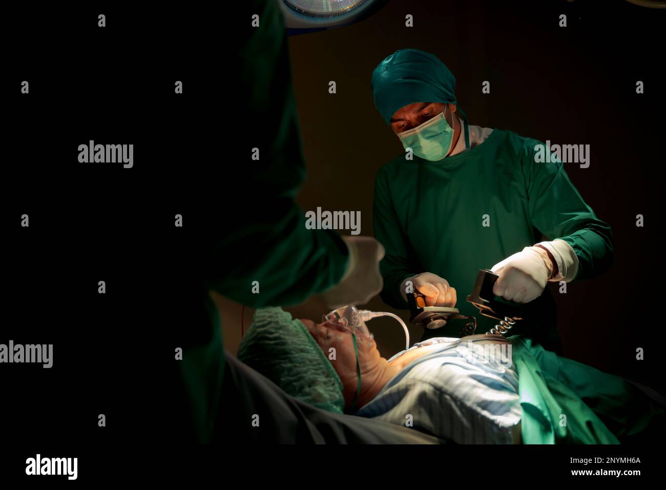 Team doctors operating room dressed green uniforms saving lives ...