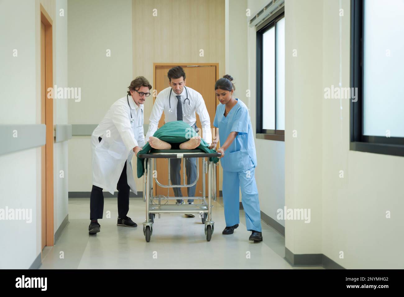 The medical team is rushing to bring the critically ill patient lying ...