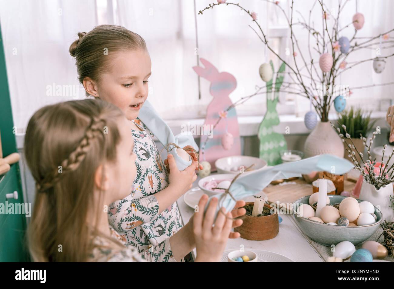 easter holiday time in spring season. happy family candid little kids ...