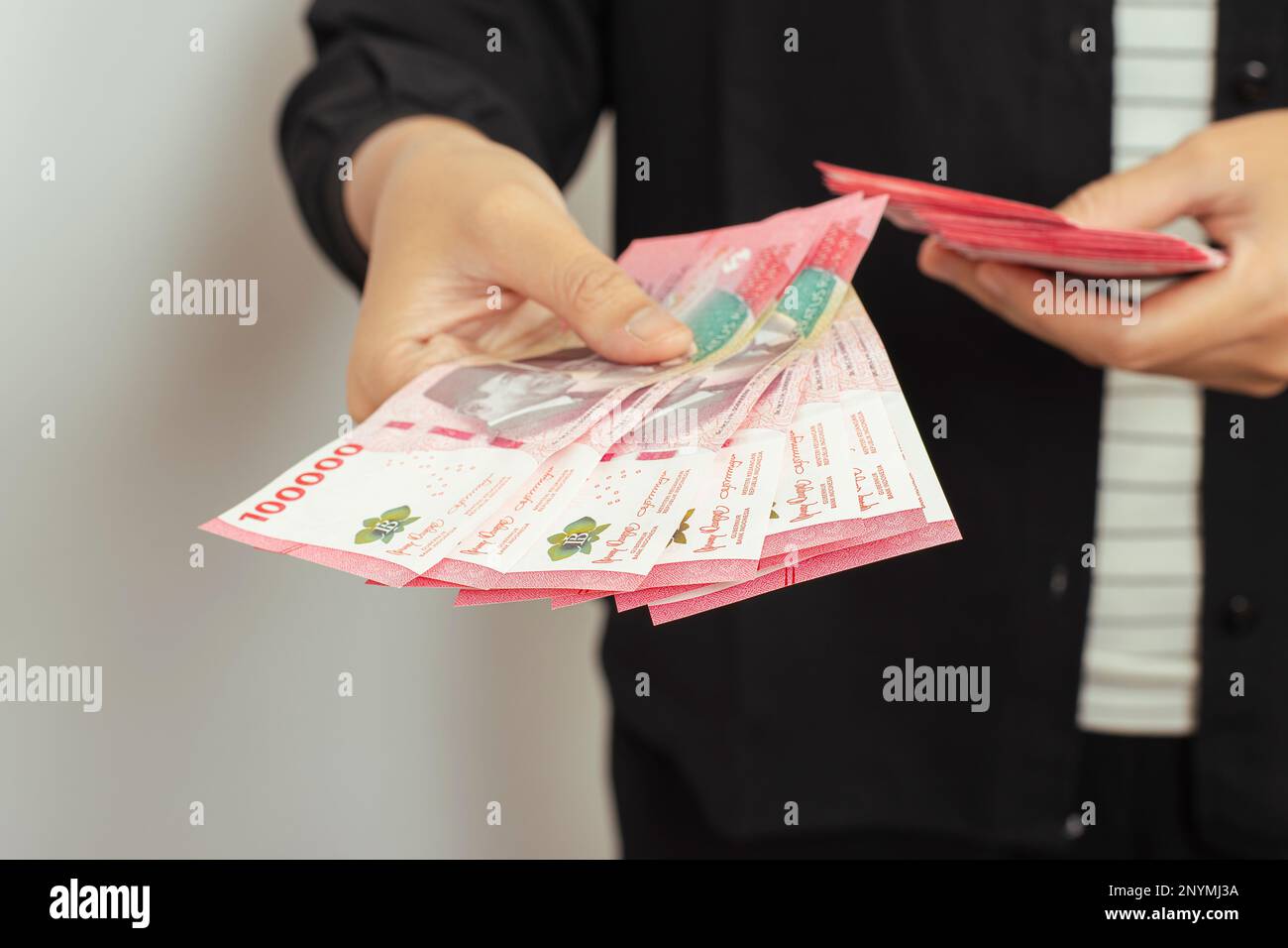 Cash payment concept. Indonesian rupiah currency (Rp. 100.000 Seratus ...