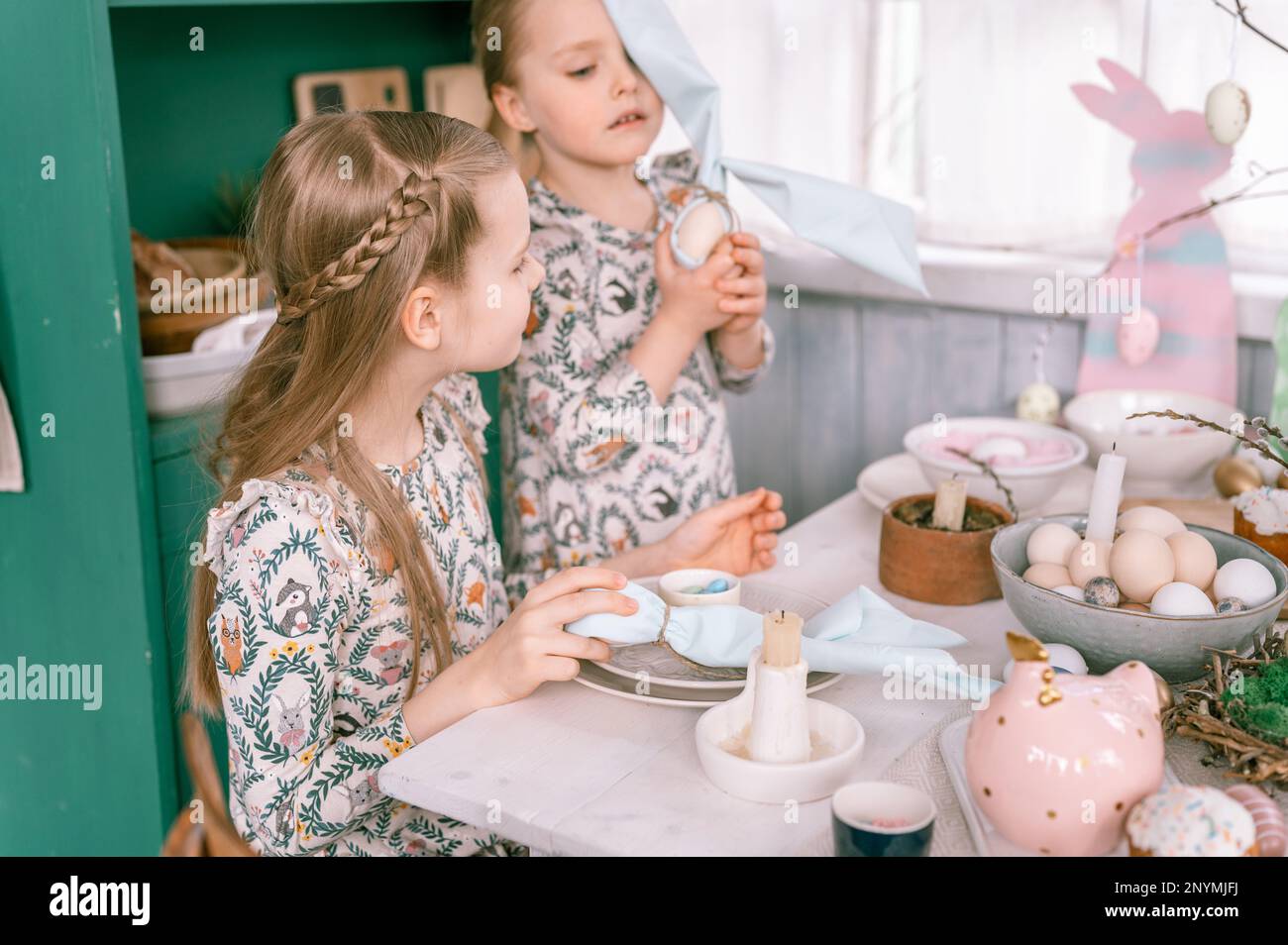 easter holiday time in spring season. happy family candid little kids ...