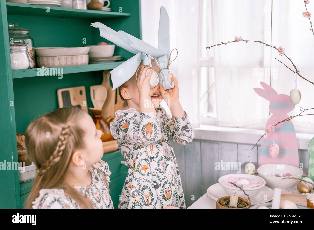 easter holiday time in spring season. happy family candid little kids ...