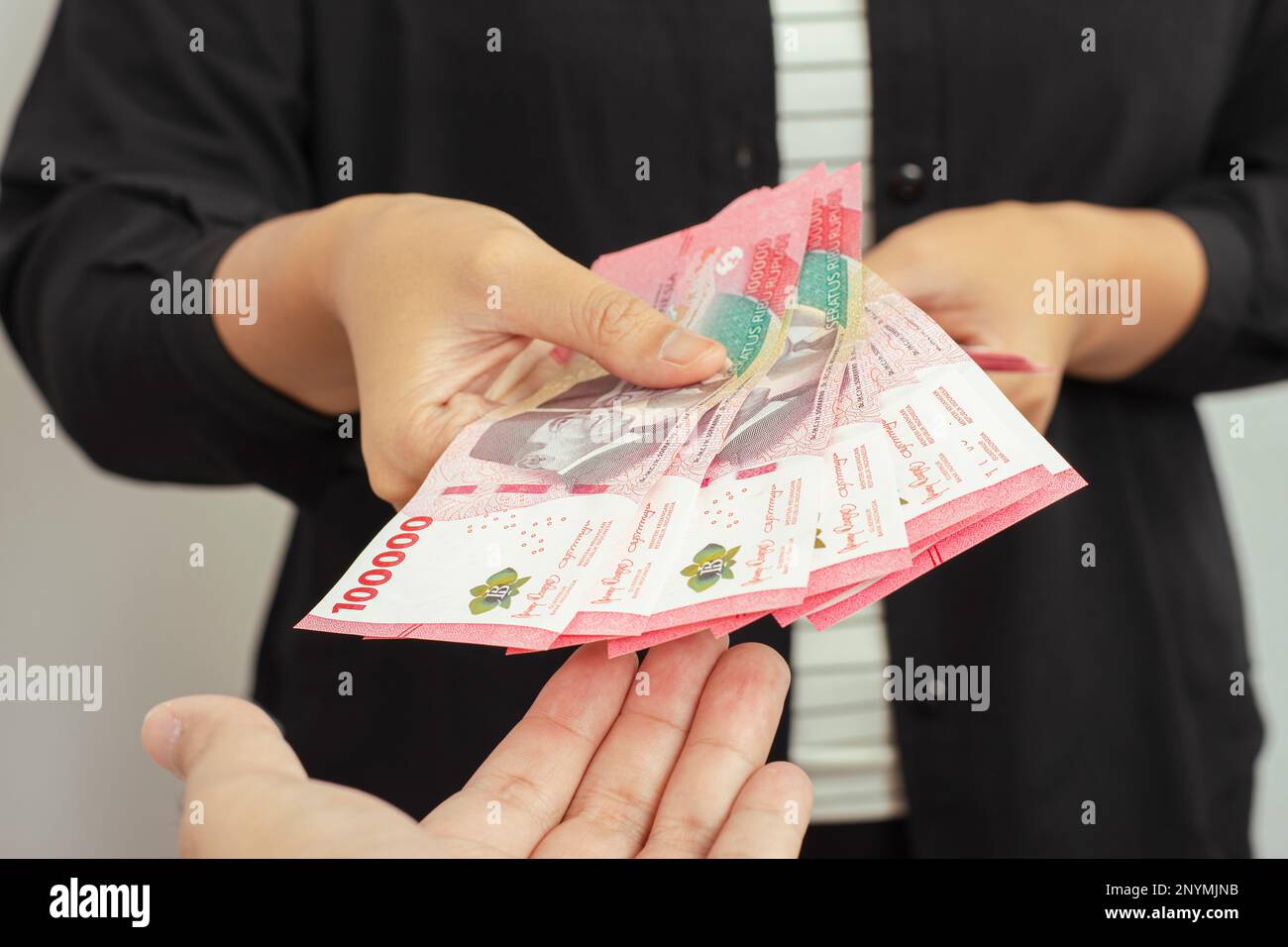 Cash payment concept. Indonesian rupiah currency (Rp. 100.000 Seratus ...