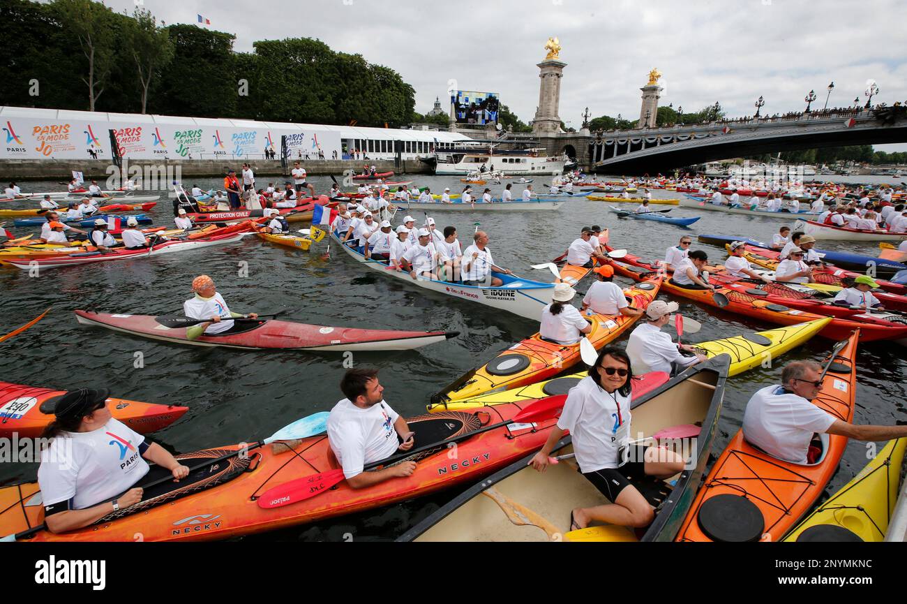 Kayakers paddle on the Seine river in Paris Friday, June 23, 2017 ...