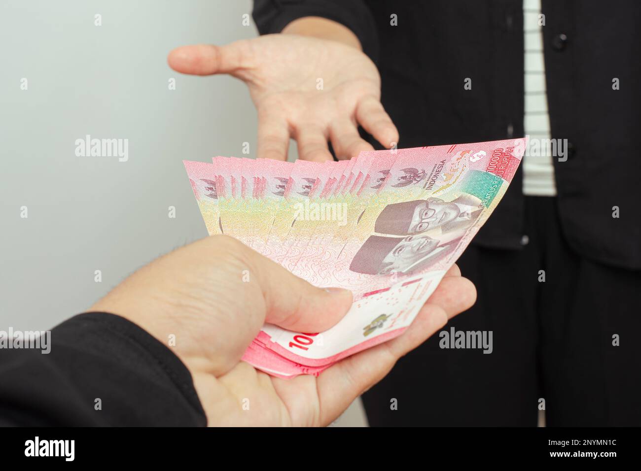 Cash payment concept. Indonesian rupiah currency (Rp. 100.000 Seratus ...