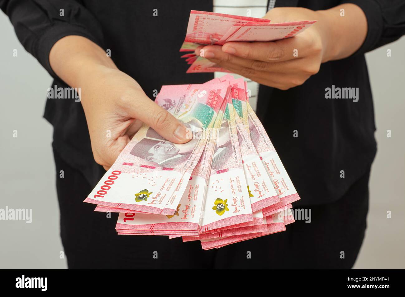 Cash payment concept. Indonesian rupiah currency (Rp. 100.000 Seratus Ribu Rupiah), One hundred ...
