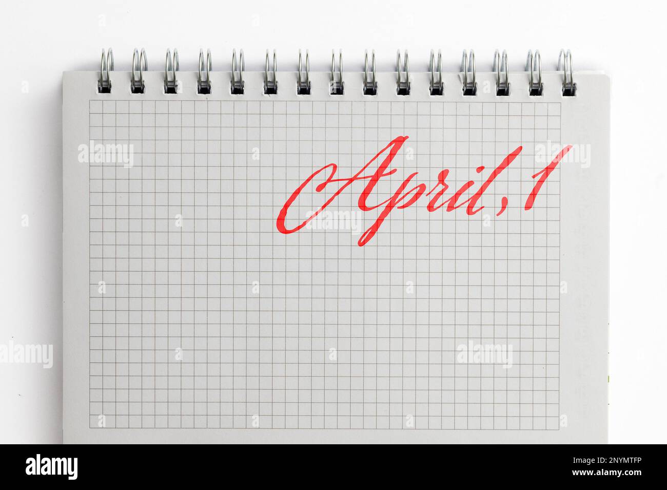 Notebook with text APRIL 1 on white background. Fool's day celebration ...
