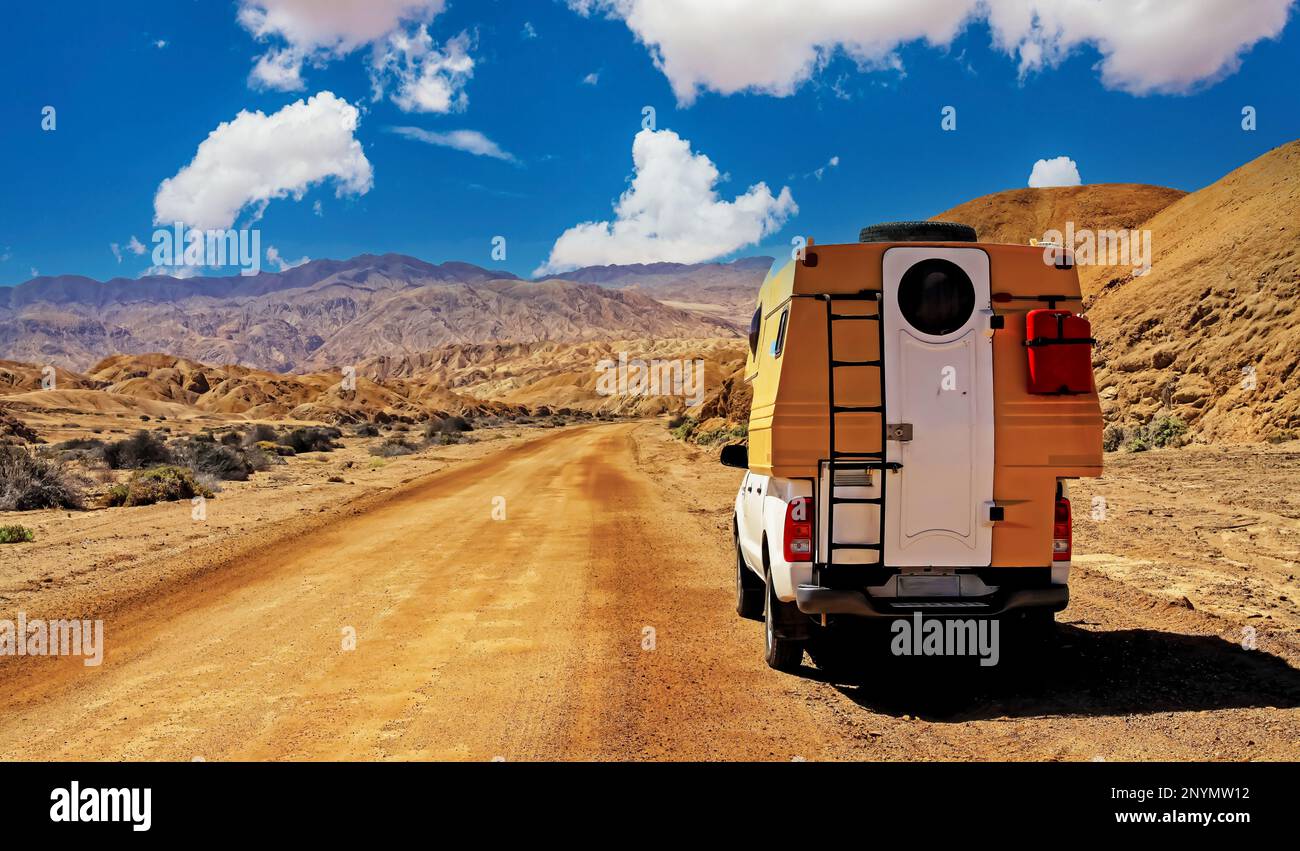 Camper truck trip on red dirt track sand road, barren lonely wild ...