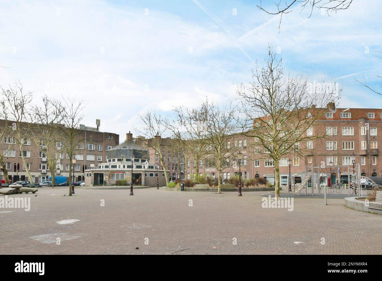 a city square with trees and buildings in the background, on a sunny ...