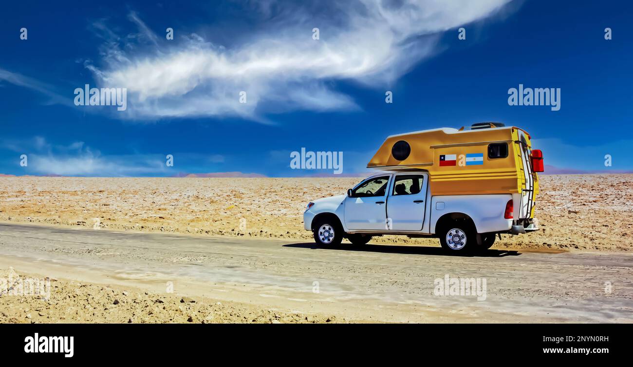 Lonely camper truck van on dirt track road in white salt flat desert ...