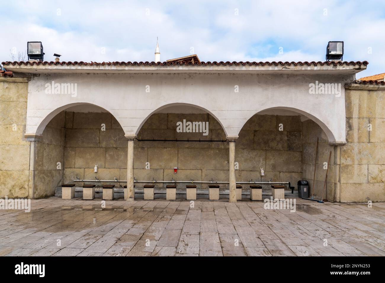 Faucets for ritual ablution and chairs to sit on near a mosque Stock ...