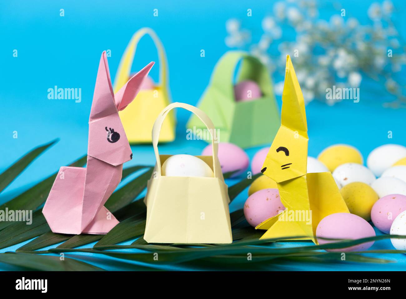 Two figures of Easter bunnies made of paper, origami crafts and a ...