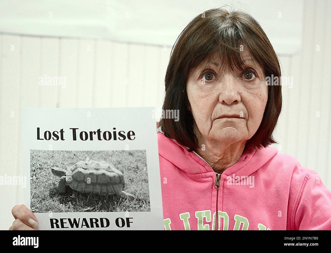 In this undated photo, Kathie Heisinger poses with a poster offering a ...