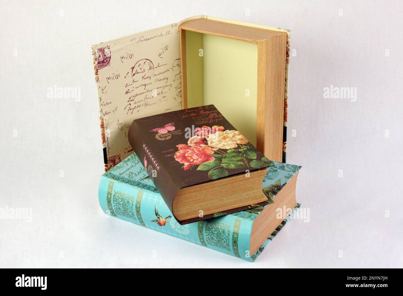 The three open book boxes featuring a floral pattern on the front cover ...