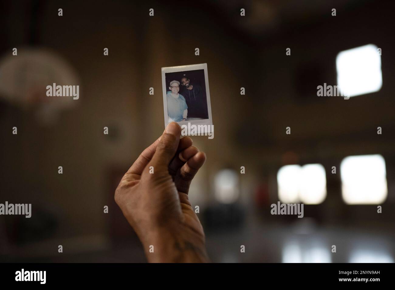 Prisoner Daniel Henson, 40, holds up an instant photo of him taken with ...