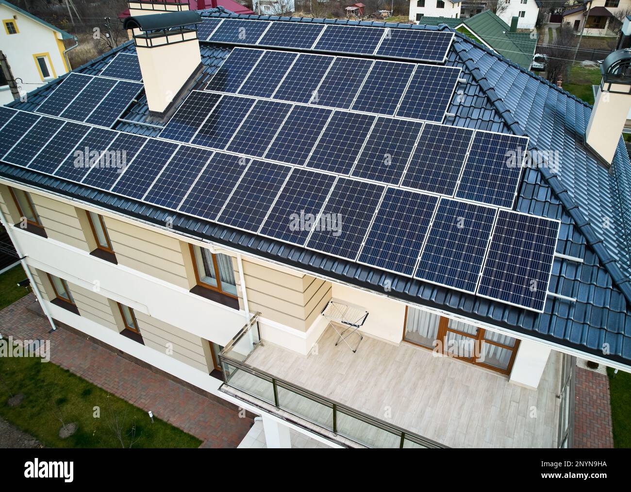 Aerial view of residential house with photovoltaic solar panel modules ...
