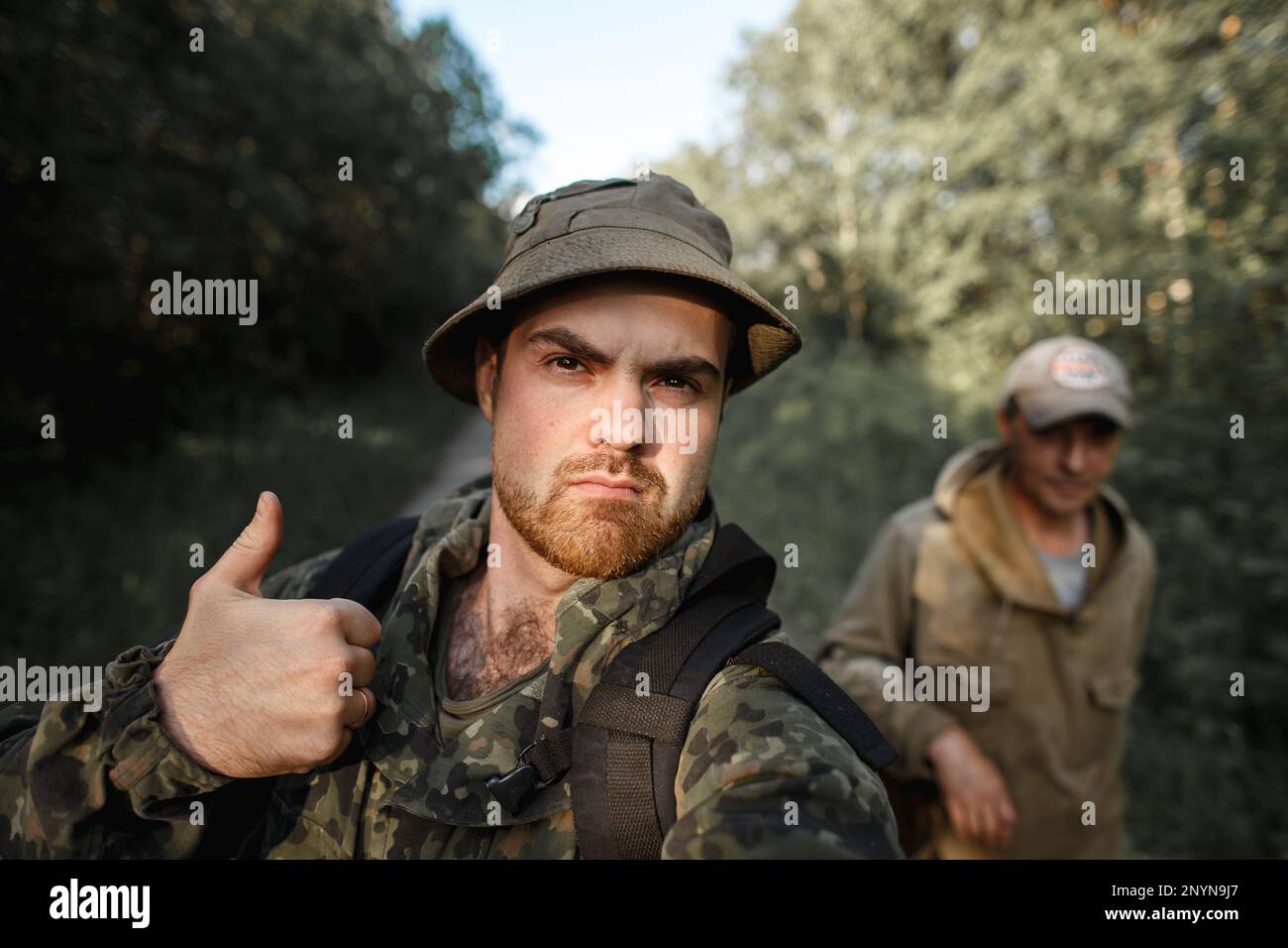 Two men in the woods. Hiking route Stock Photo - Alamy