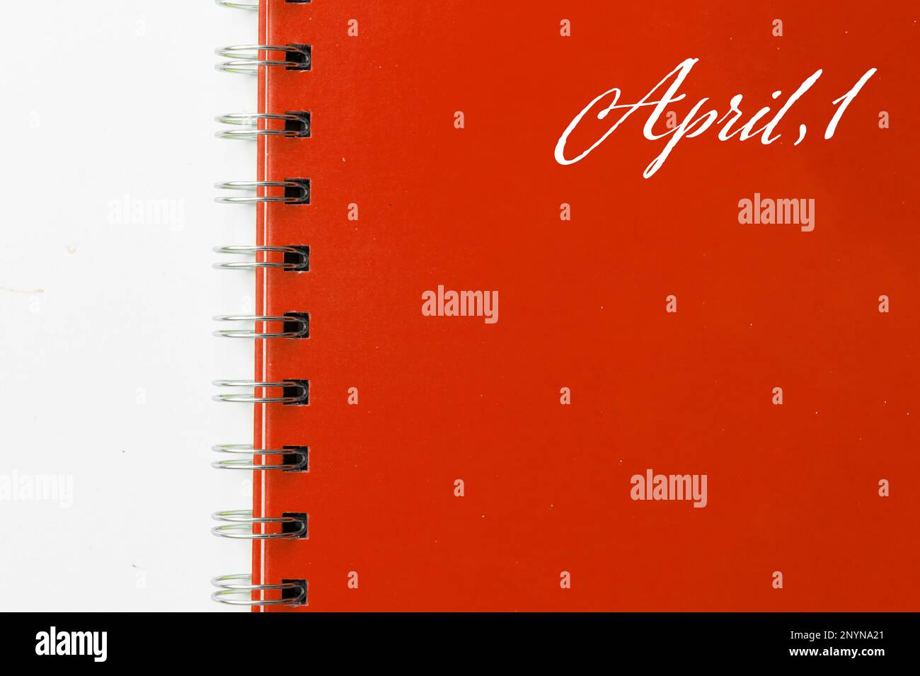 Red notebook with text APRIL 1 on white background. Fool's day ...