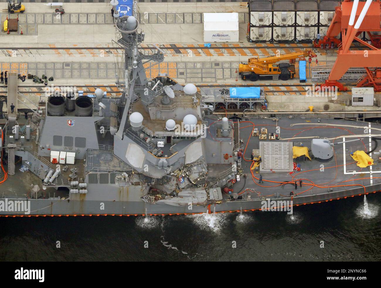 This aerial photo shows the USS Fitzgerald (8,315t), damaged by the ...