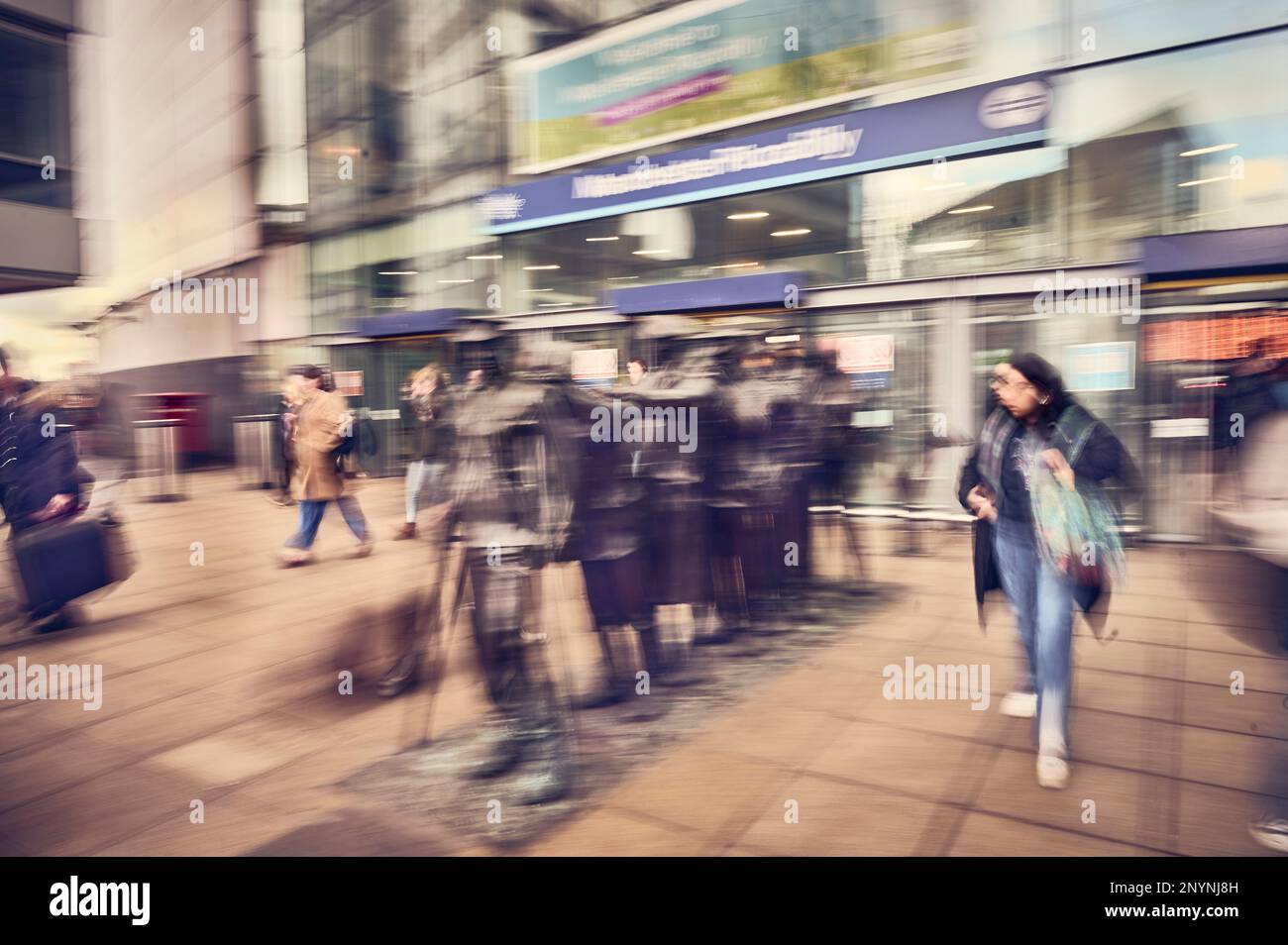 Train commuters rushing past the statue 'Victory over blindness ...